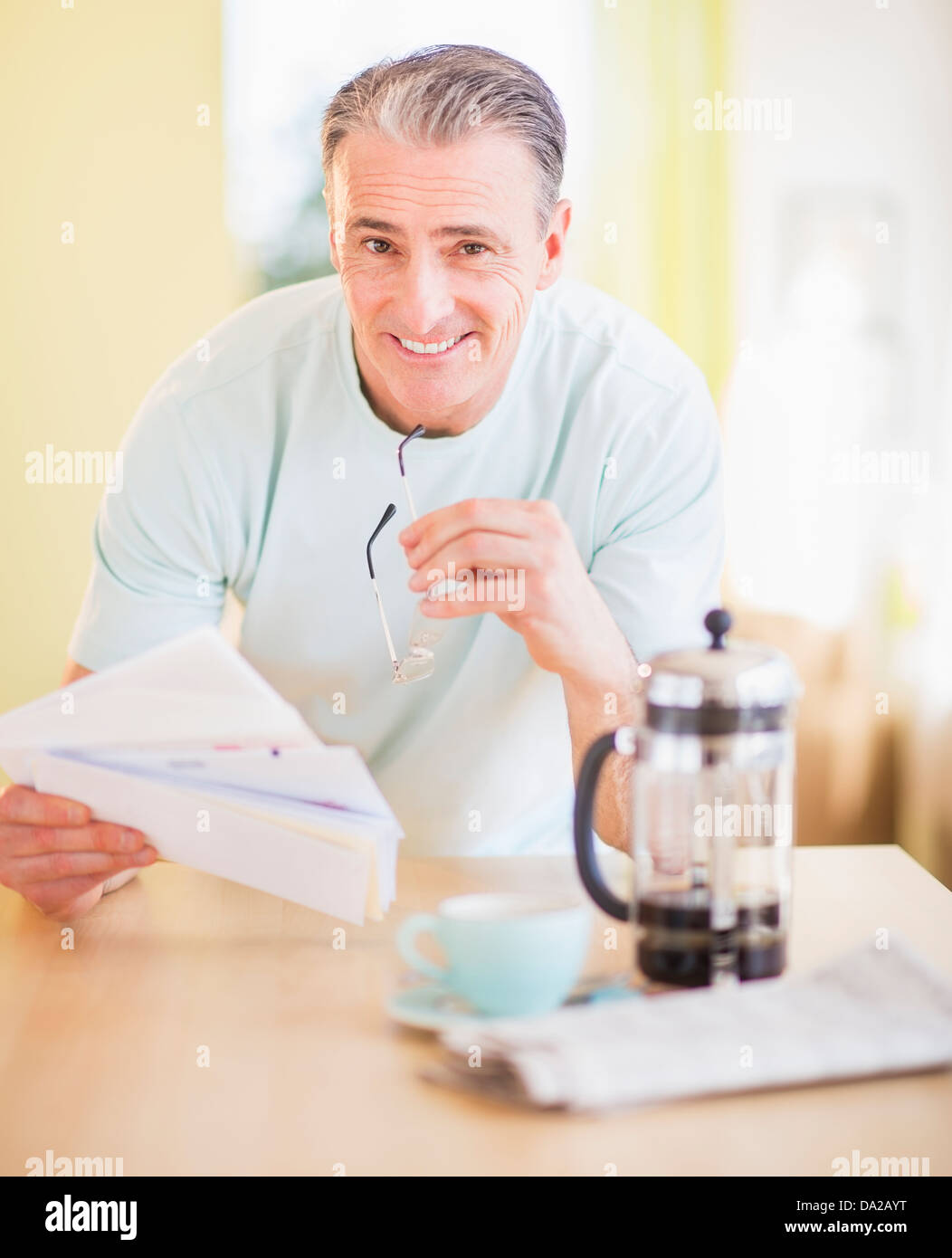 Portrait of man at kitchen table Stock Photo - Alamy