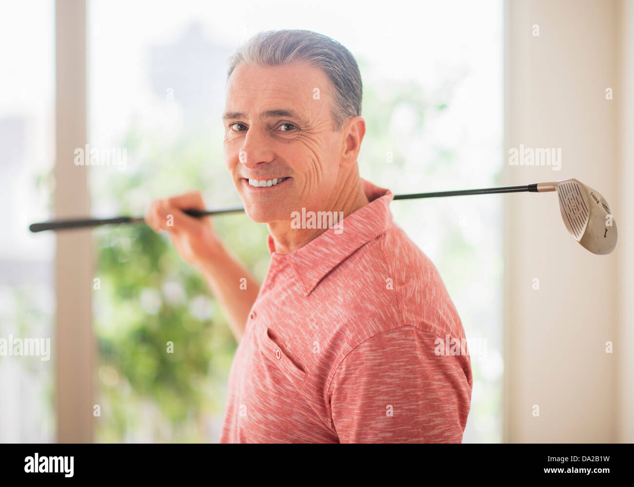 Portrait of man holding golf club on his shoulder Stock Photo - Alamy