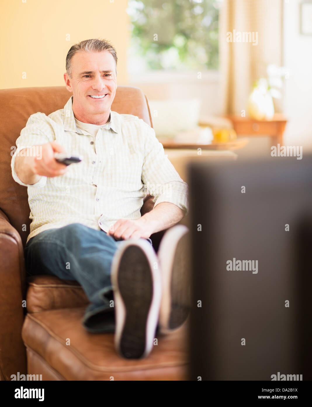 Portrait of man watching tv Stock Photo - Alamy