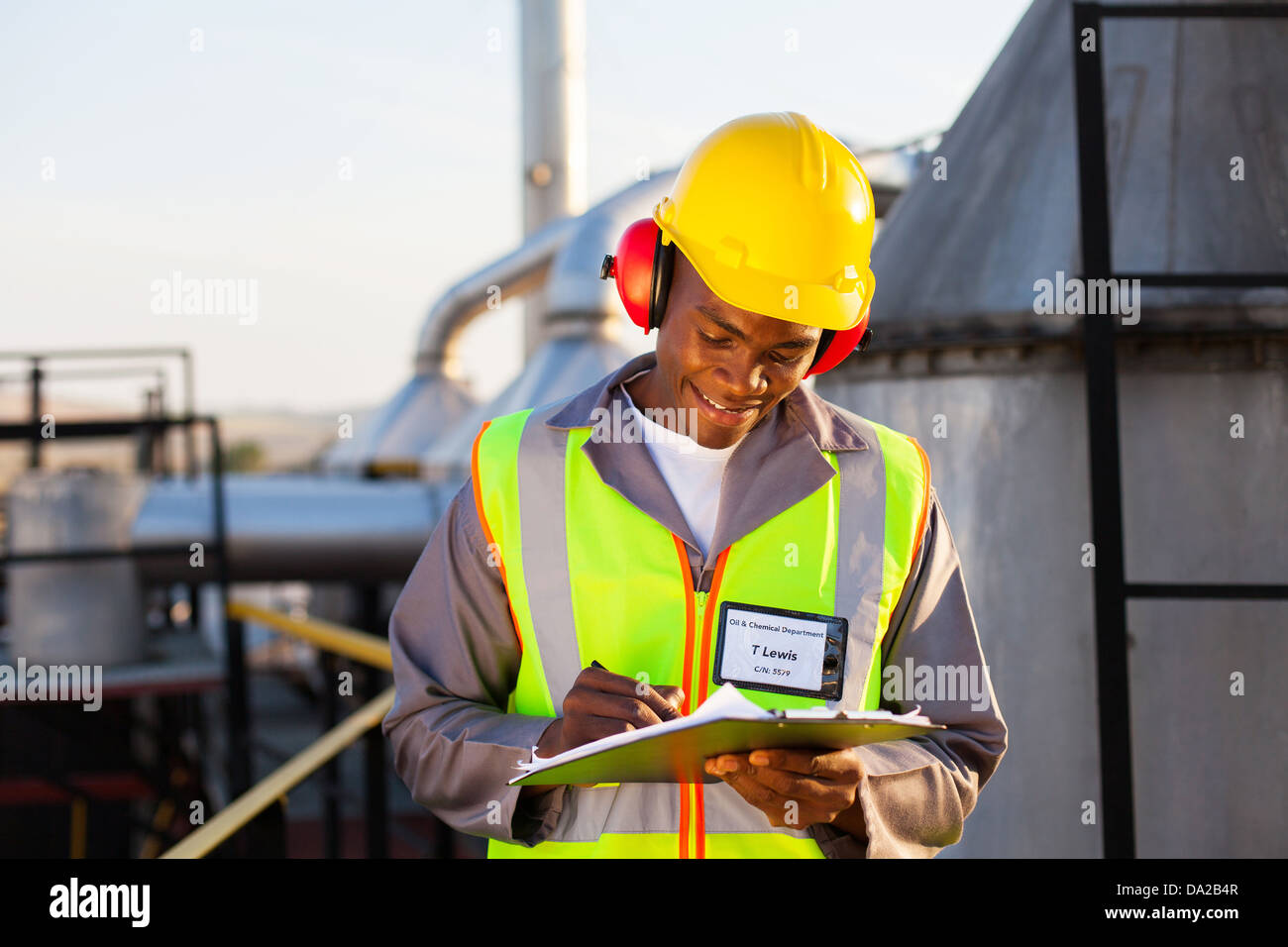 happy african american oil chemical industry worker working in plant ...