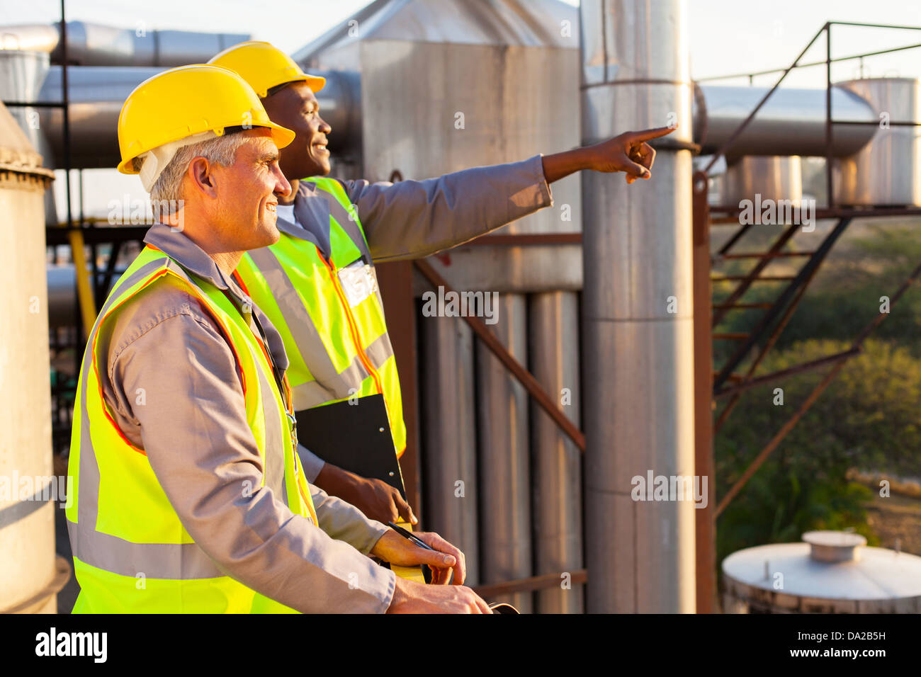 two chemical factory workers working in plant Stock Photo - Alamy