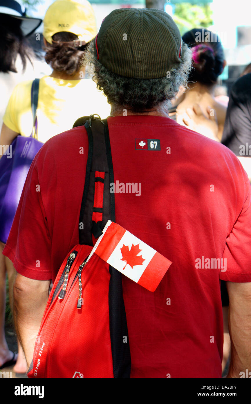Man with a Canadian flag attached to his backpack at Canada Day ...