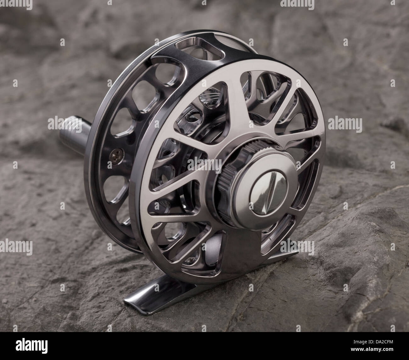 reel fishing rod on a blue background Stock Photo - Alamy