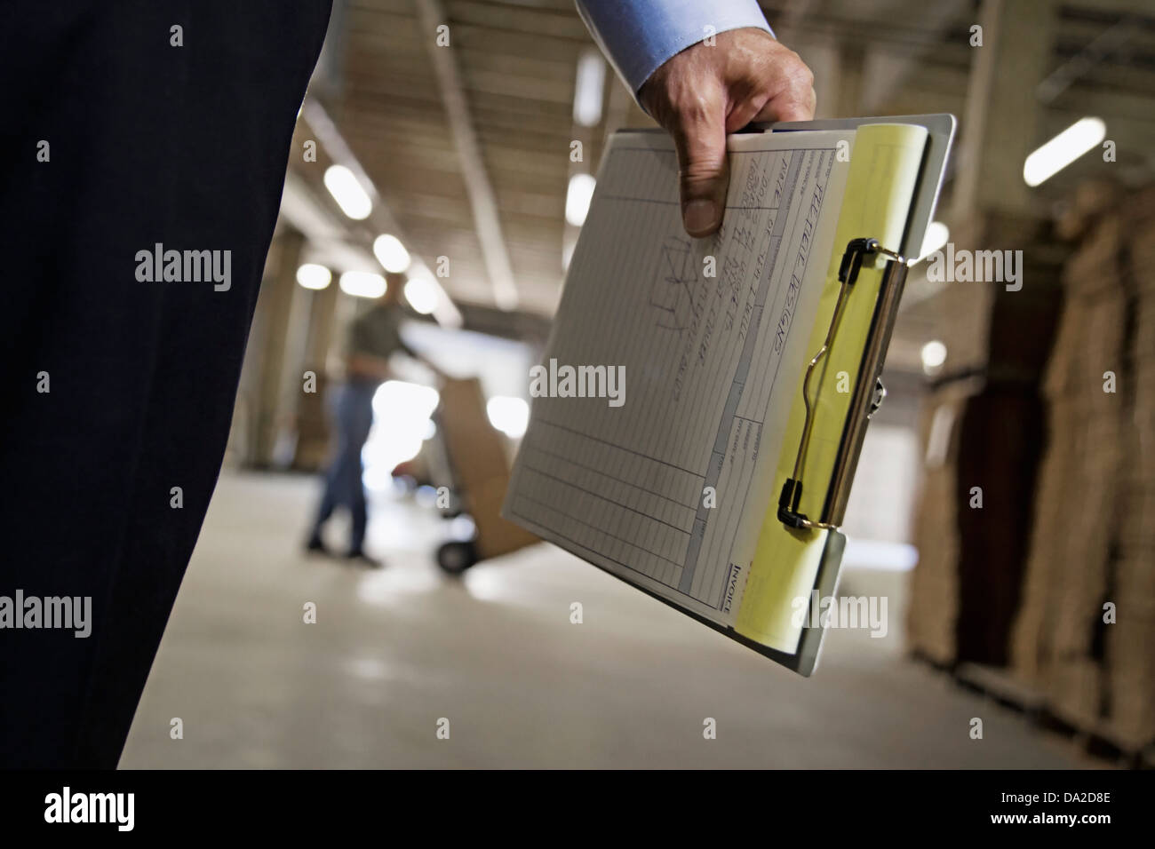 Close up of man holding clipboard in warehouse Stock Photo - Alamy