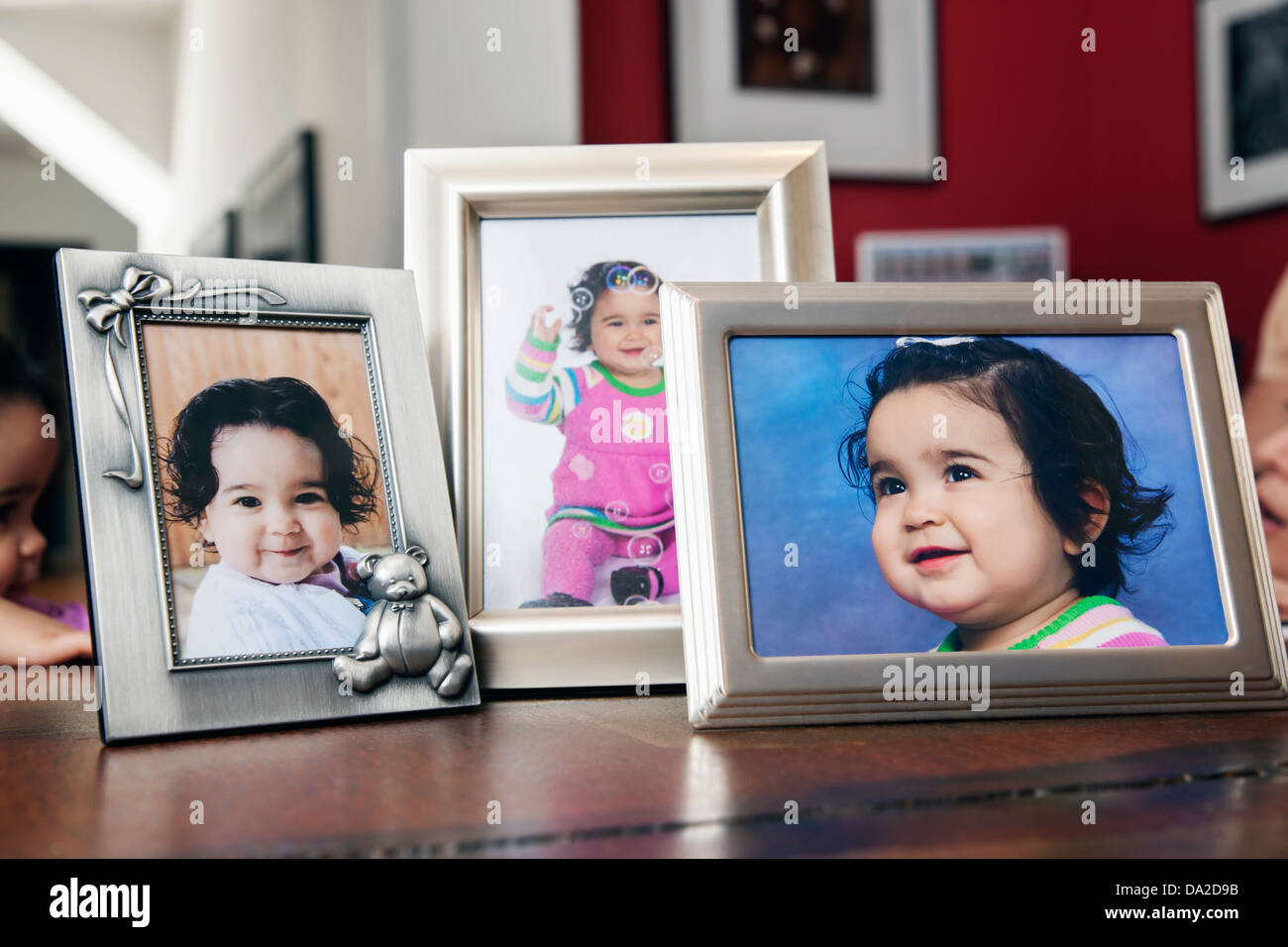 Children's portraits in frames on table Stock Photo - Alamy
