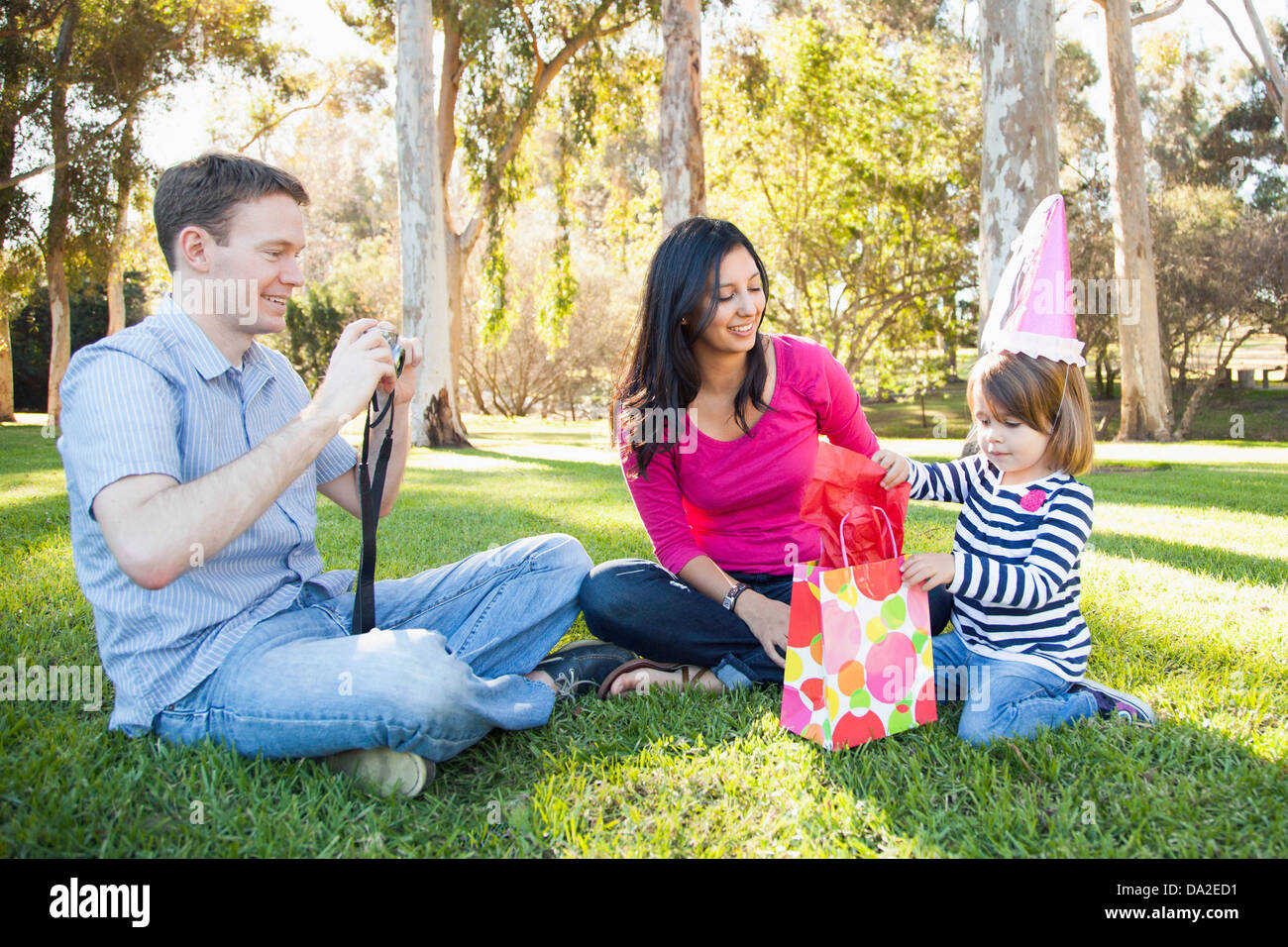 USA, California, Irvine, Family with daughter (4-5) playing in park ...