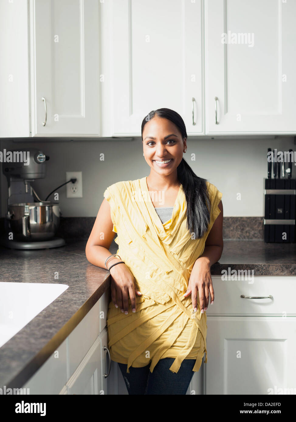 Portrait of woman standing in kitchen Stock Photo - Alamy