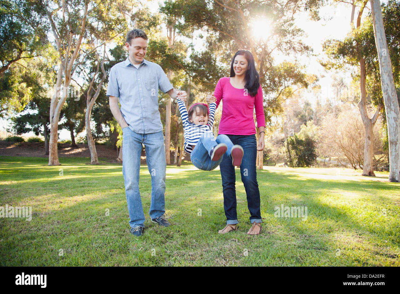USA, California, Irvine, Family with daughter (4-5) playing in park ...