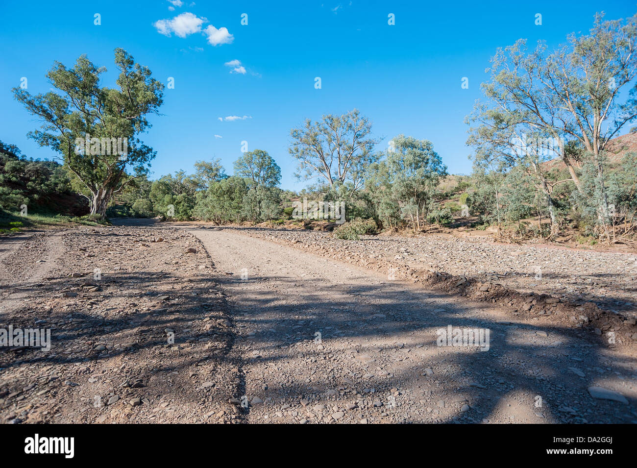 A dusty dirt outback road graded through a dry river bed in South ...