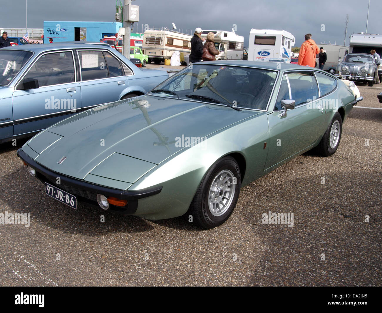This photograph captures a classic car, identified as the 1976 Bitter ...