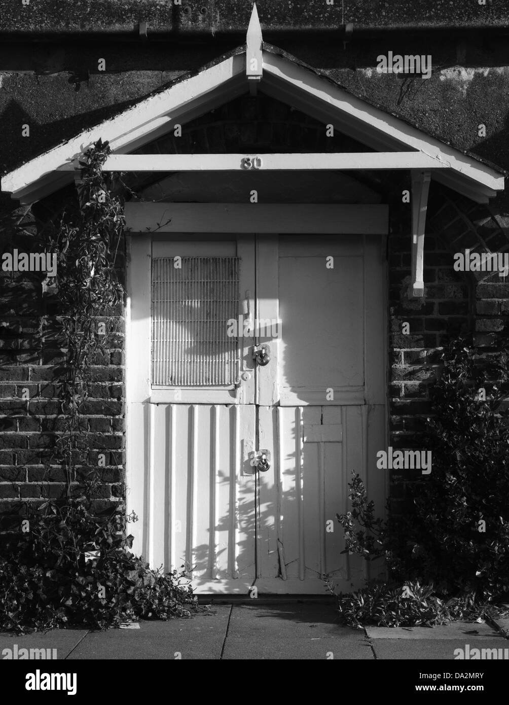 Overgrown seaside arch door, Brighton, UK Stock Photo - Alamy