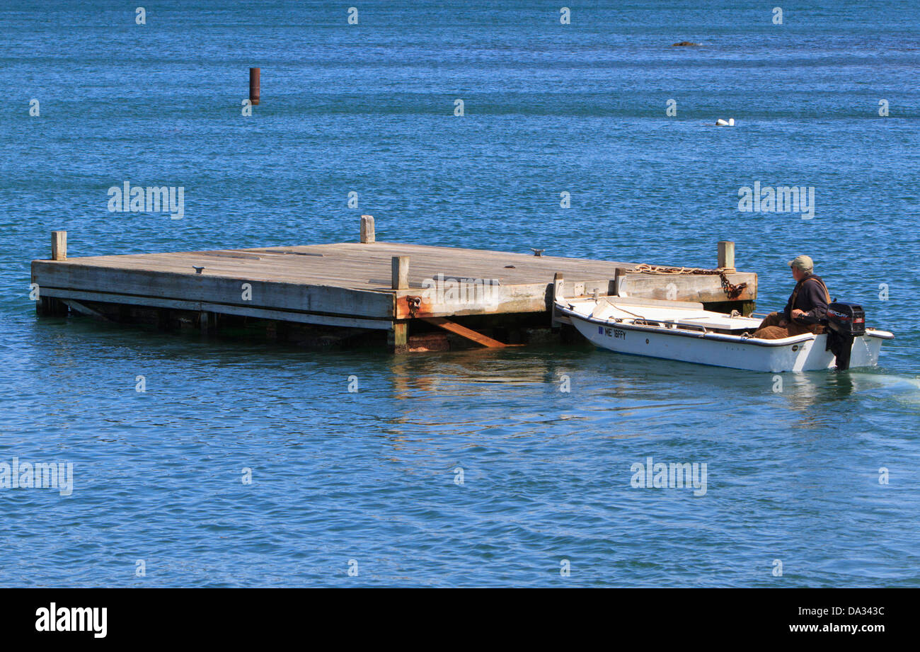 Man pushing summer dock into position in Bar Harbor Stock Photo - Alamy