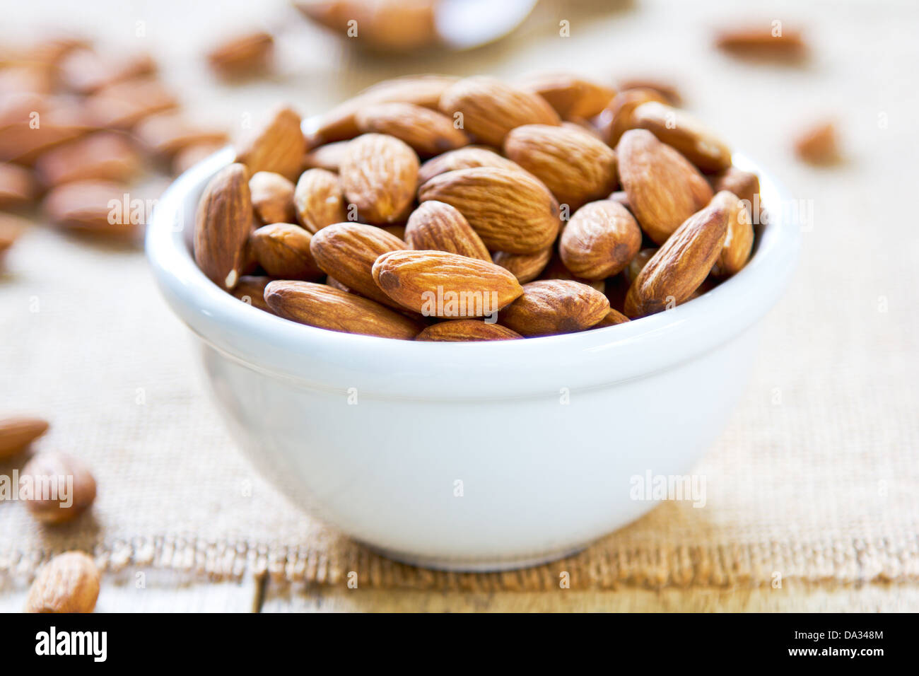 Almonds in a white bowl Stock Photo - Alamy