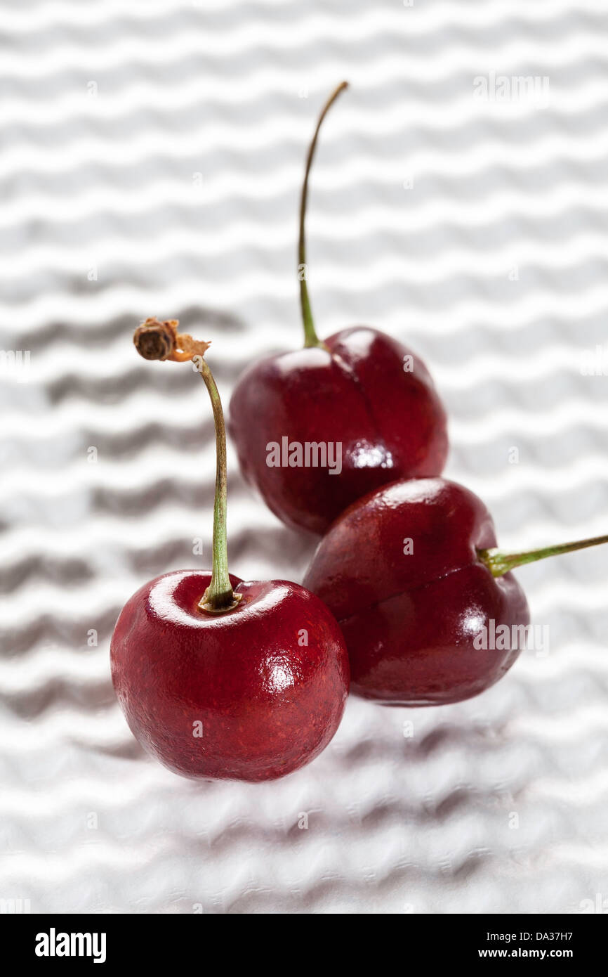Three Cherries on White Background Stock Photo - Alamy