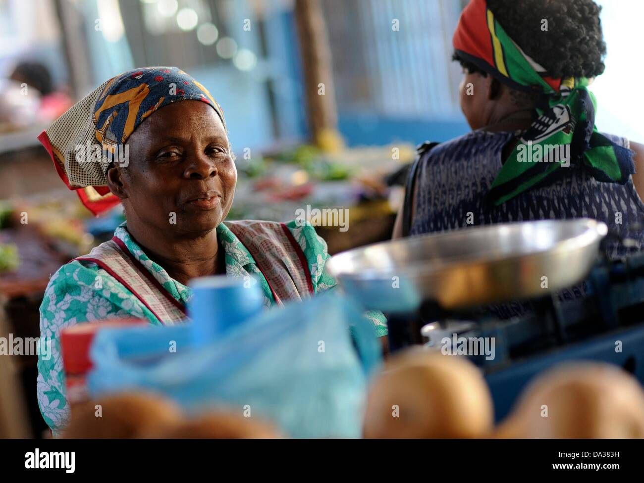 A woman sells fruit and vegetables at a market in Maputo, Mozambique ...