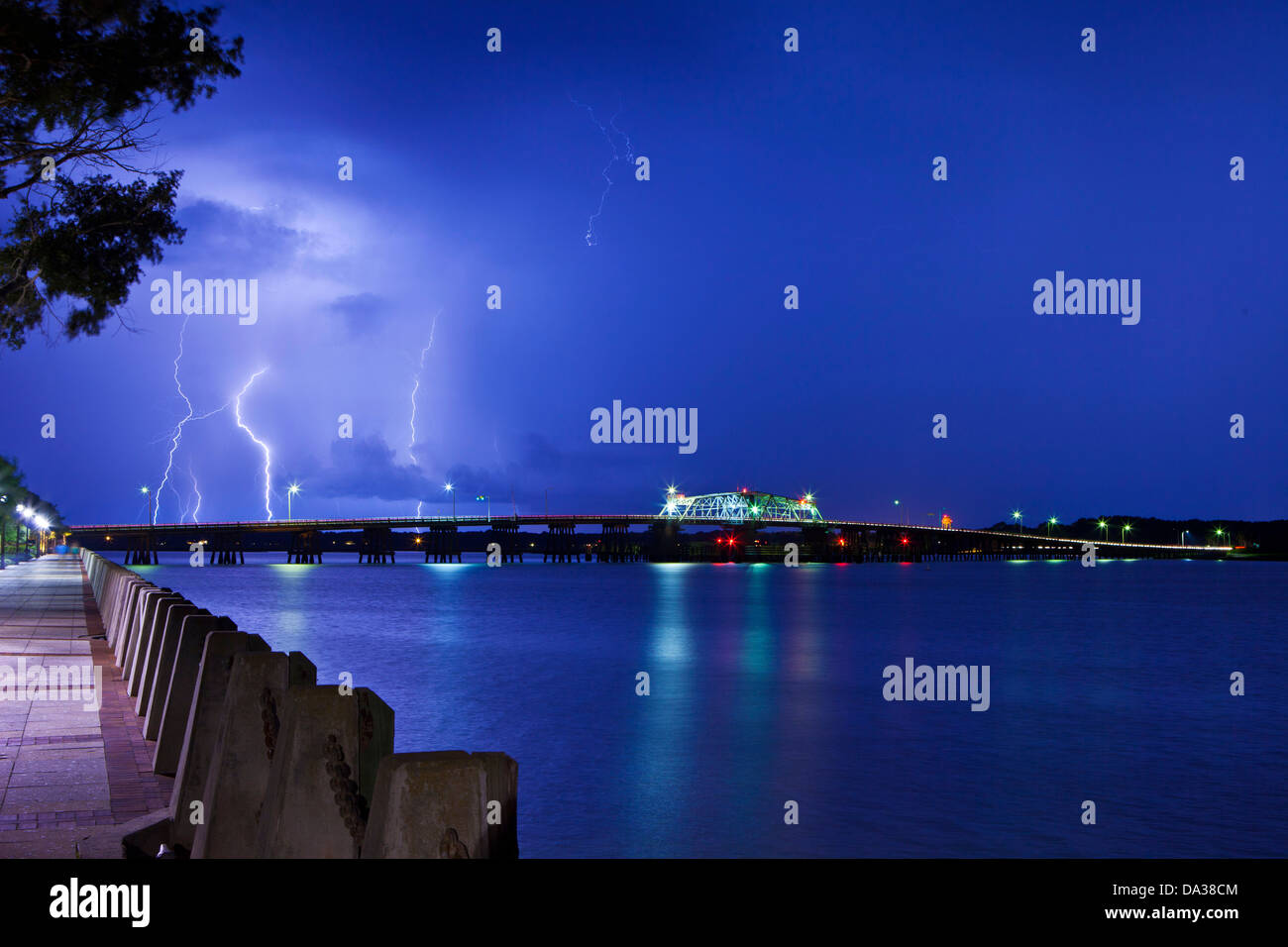 lightning striking on waterfront at night and bridge Stock Photo - Alamy