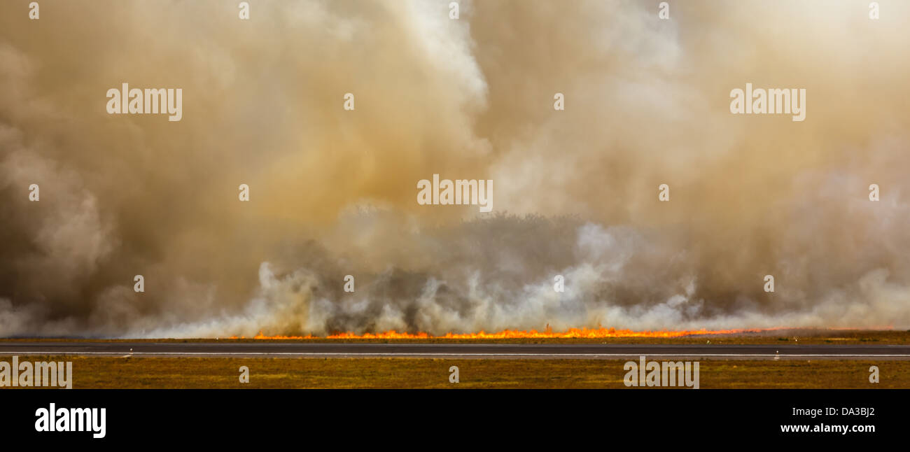 Row of flames approach runway at San Salvador International Airport ...