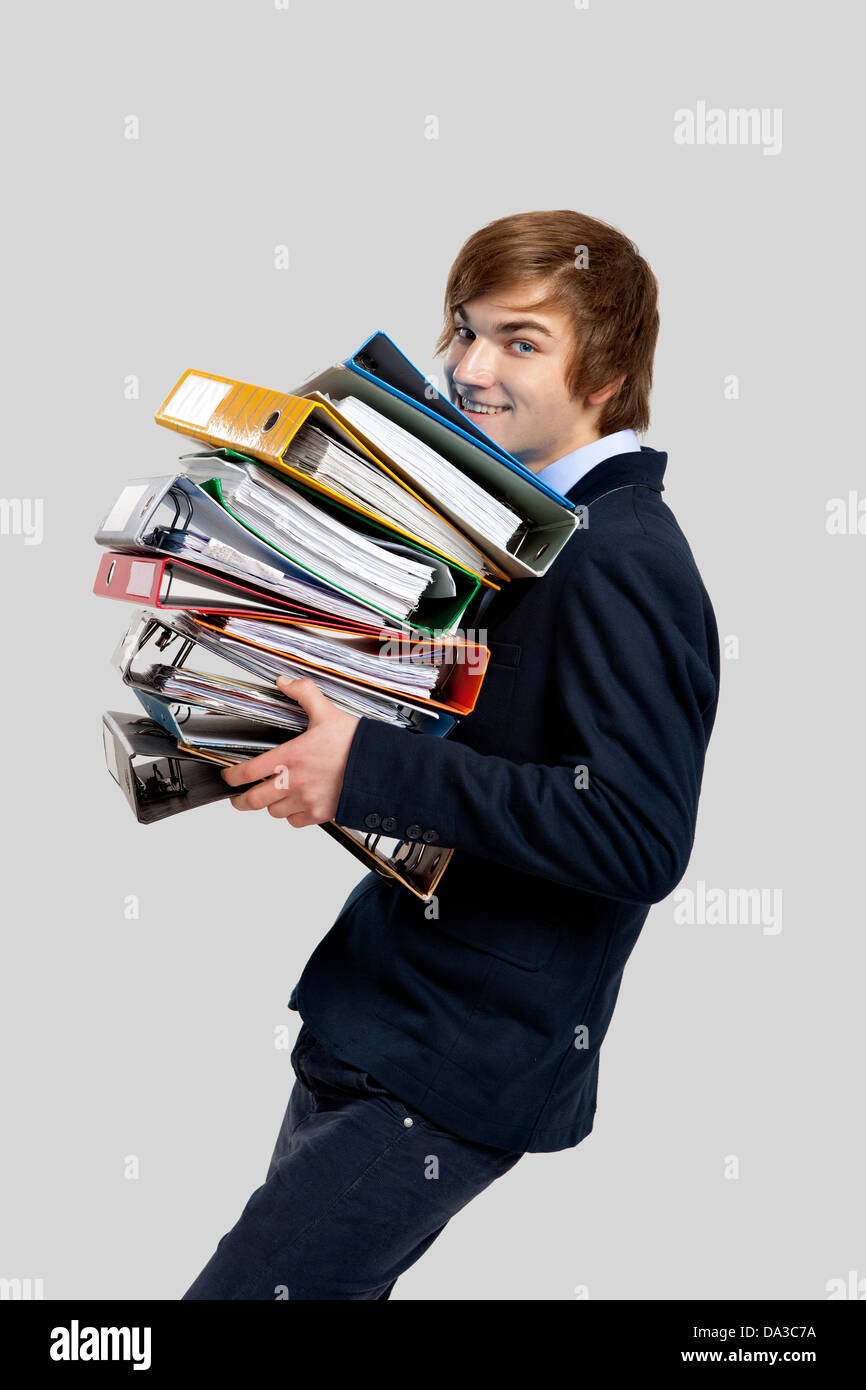 Young business man carrying a bunch of folders Stock Photo - Alamy