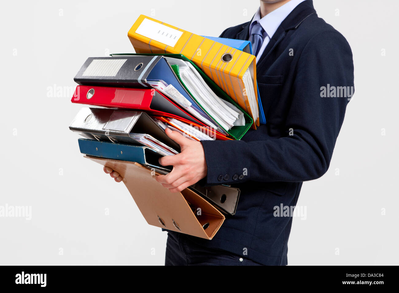 Young business man carrying a bunch of folders Stock Photo - Alamy