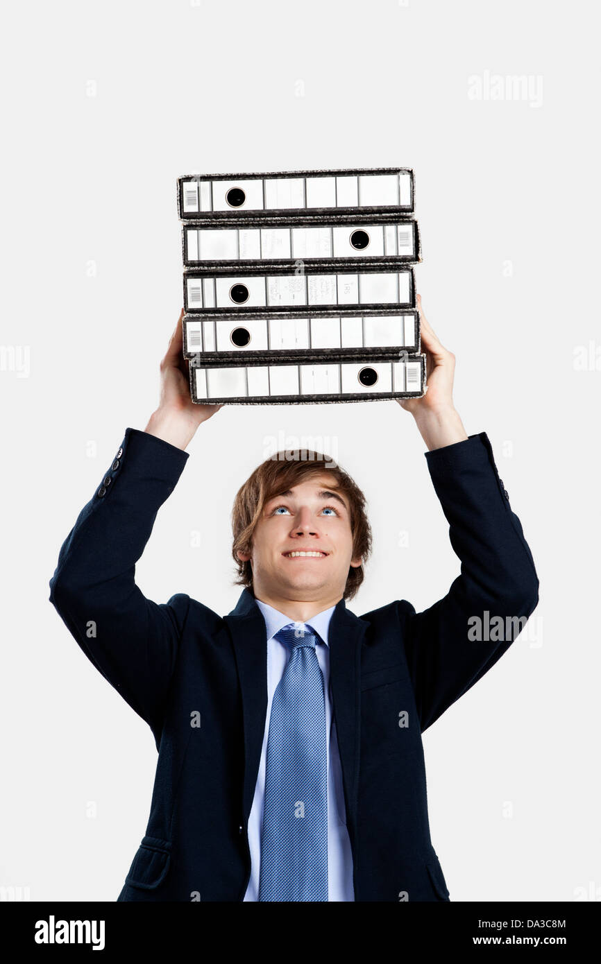 Young business man carrying a bunch of folders Stock Photo - Alamy