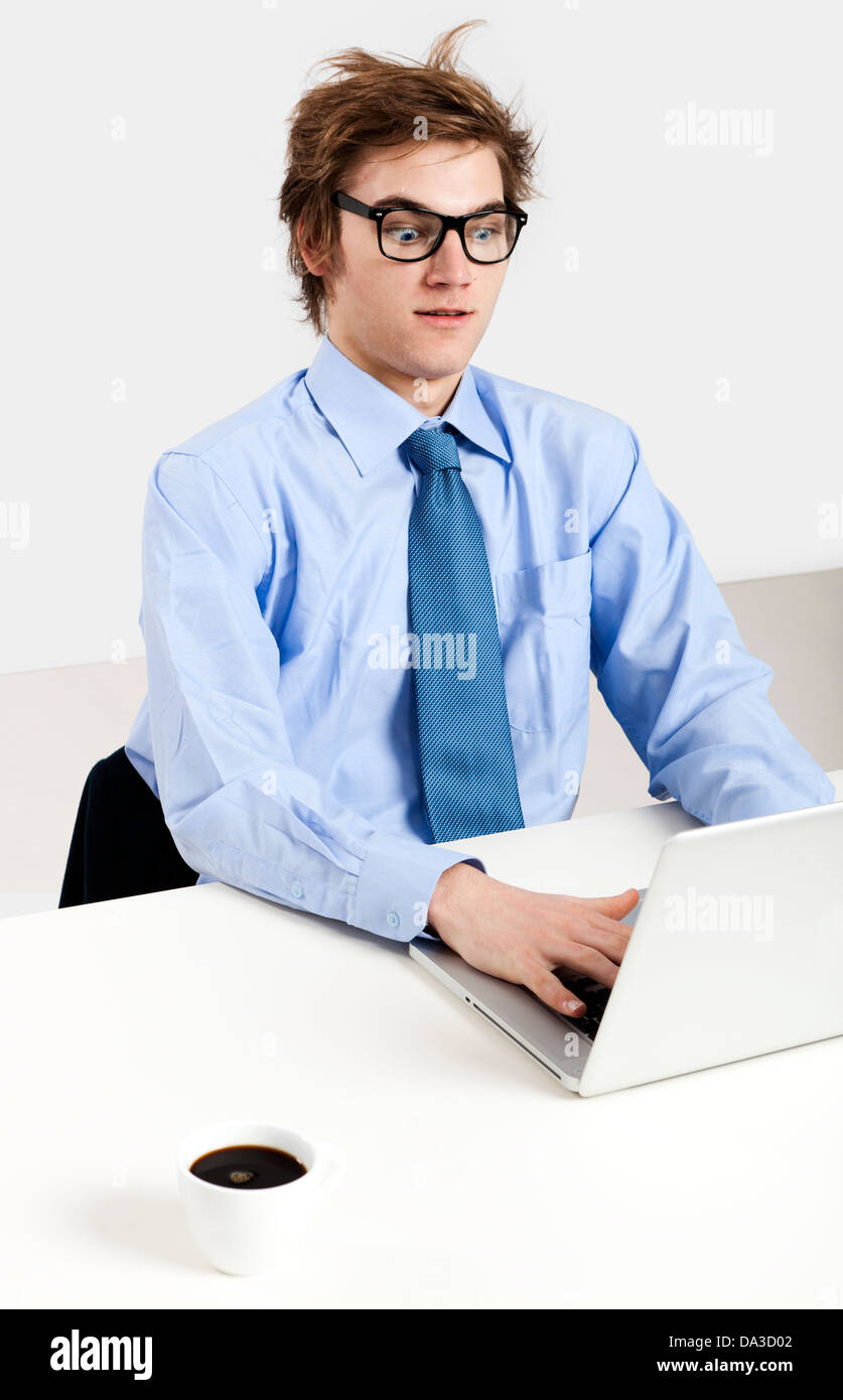 Young man in the office working in the laptop Stock Photo - Alamy