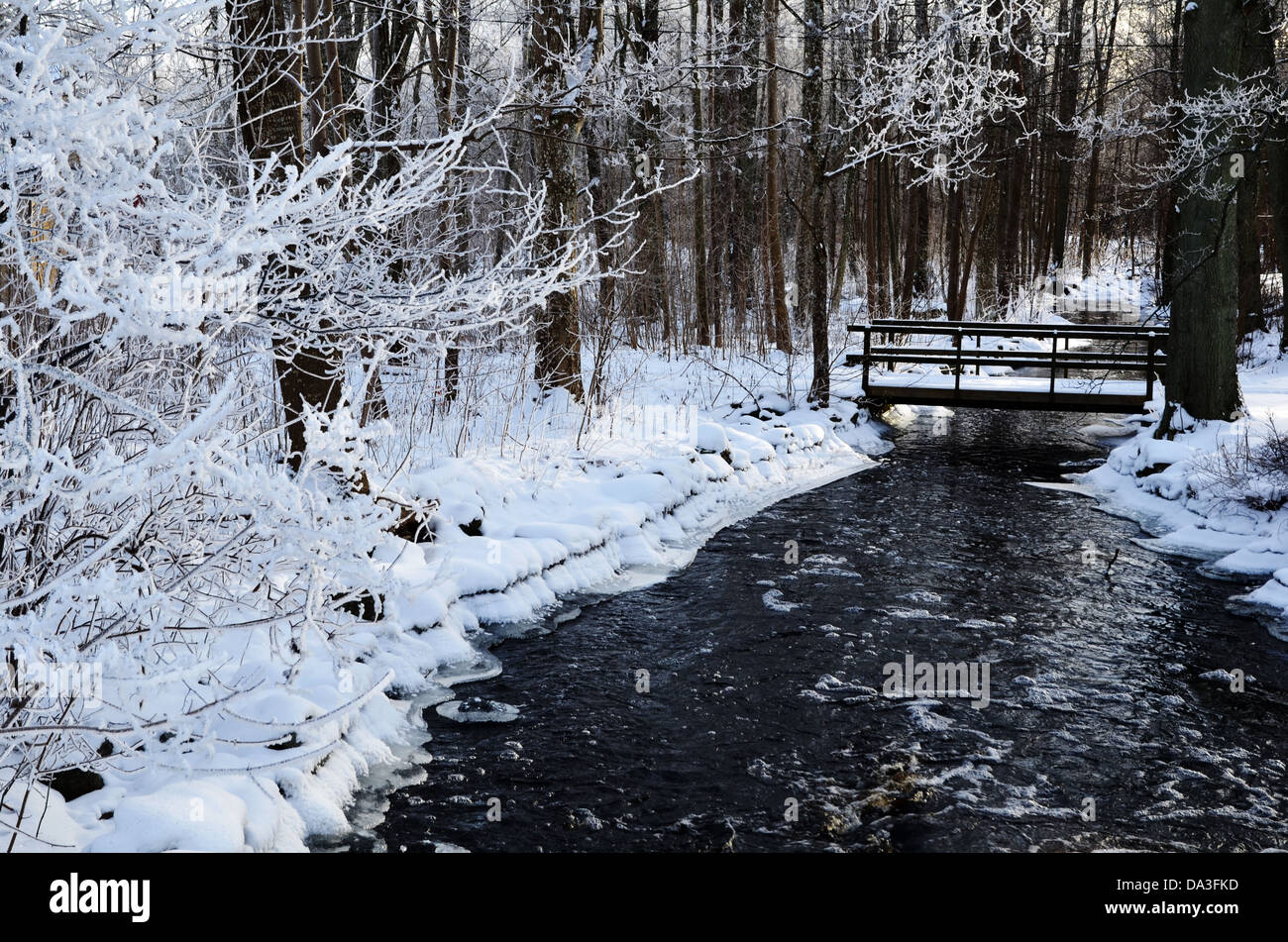 Footbridge at a small river Stock Photo - Alamy