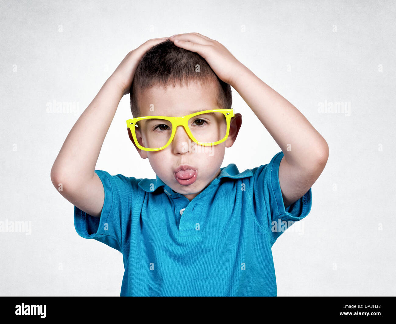 Little boy holding hands on his head Stock Photo - Alamy