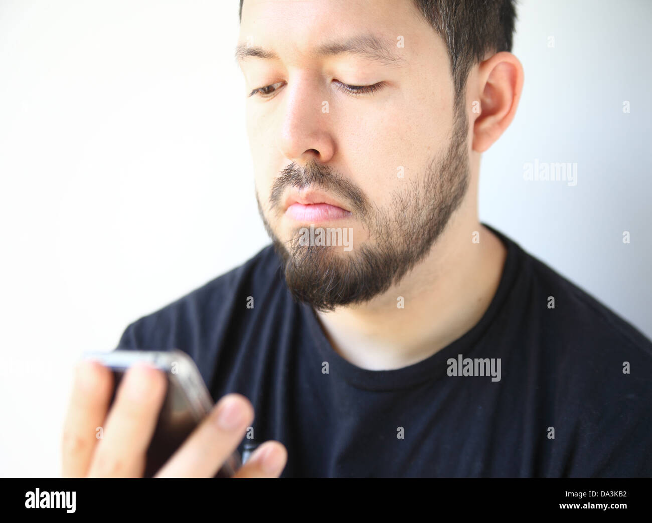 man looking down at his smartphone Stock Photo - Alamy