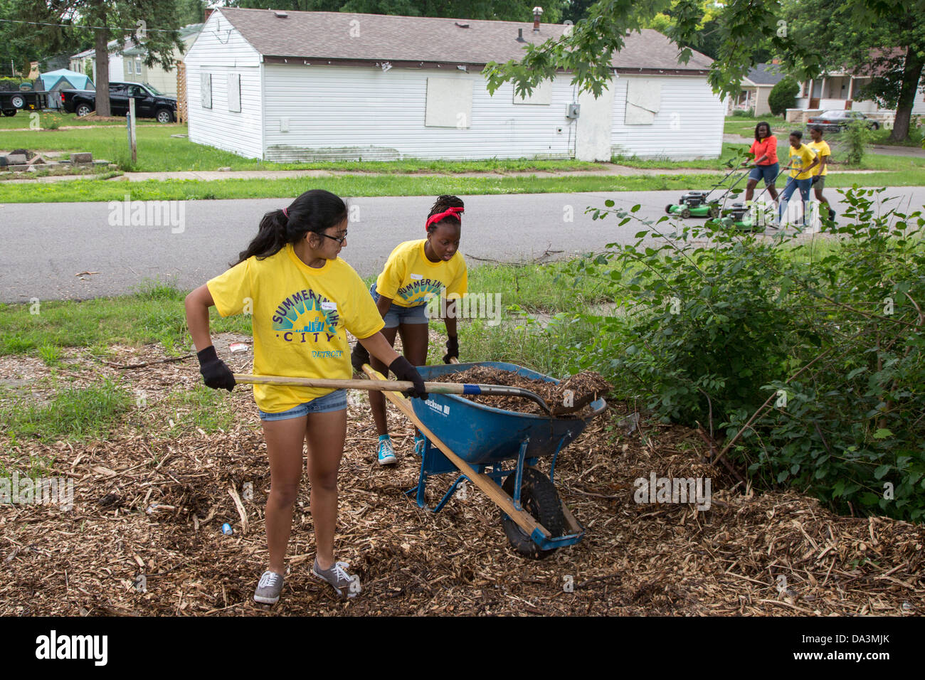 High school volunteers work in a community garden in Brightmoor, one of ...