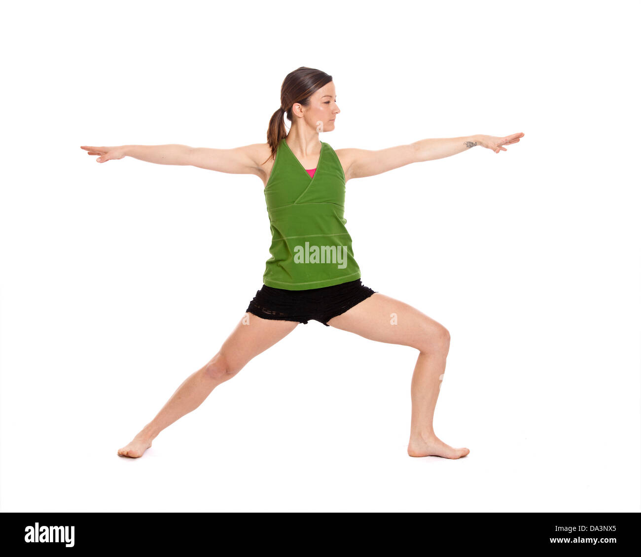 young woman doing warrior position, clipping path included Stock Photo ...