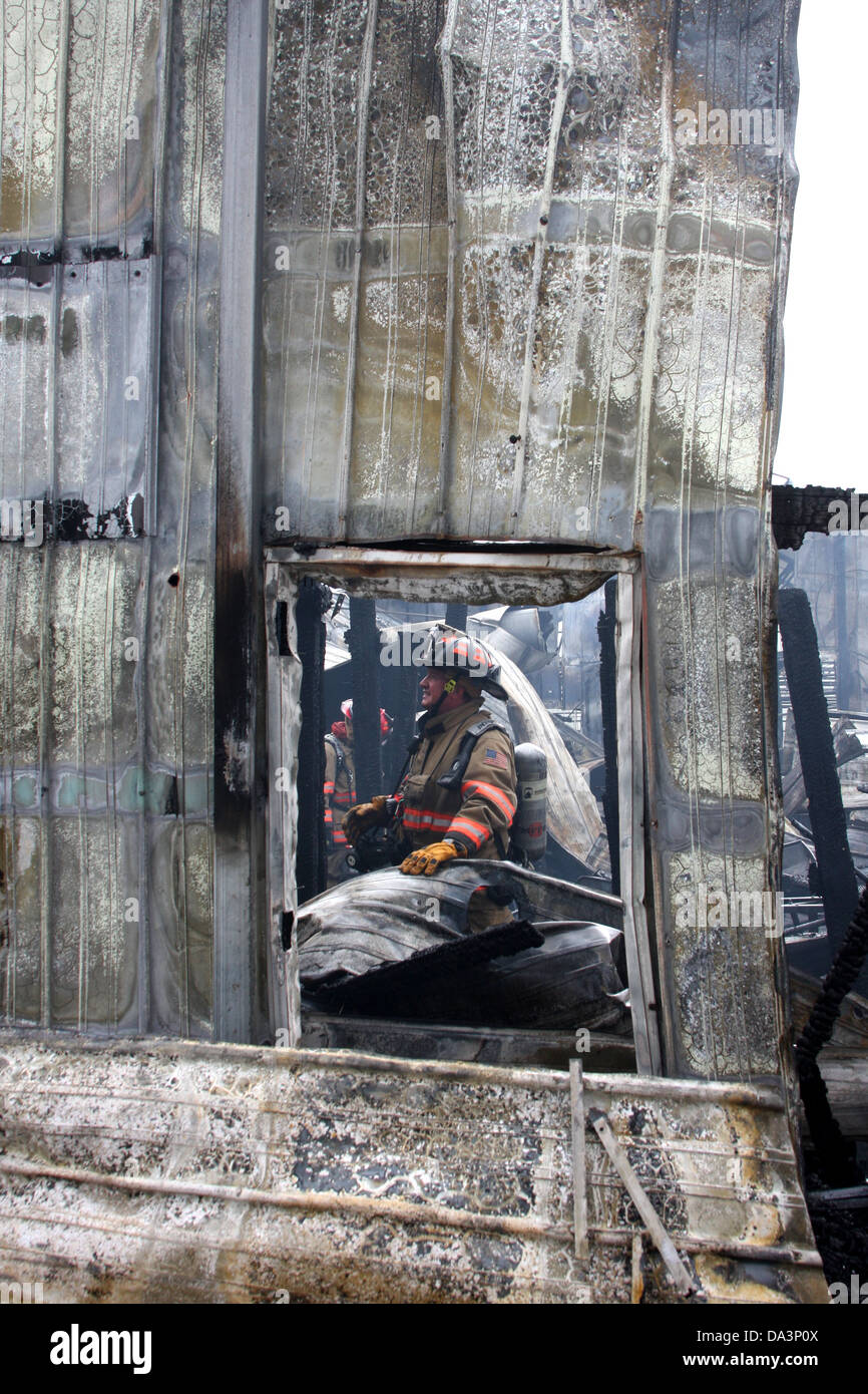 A firefighter framed in a window of a fire collapsed building Stock ...