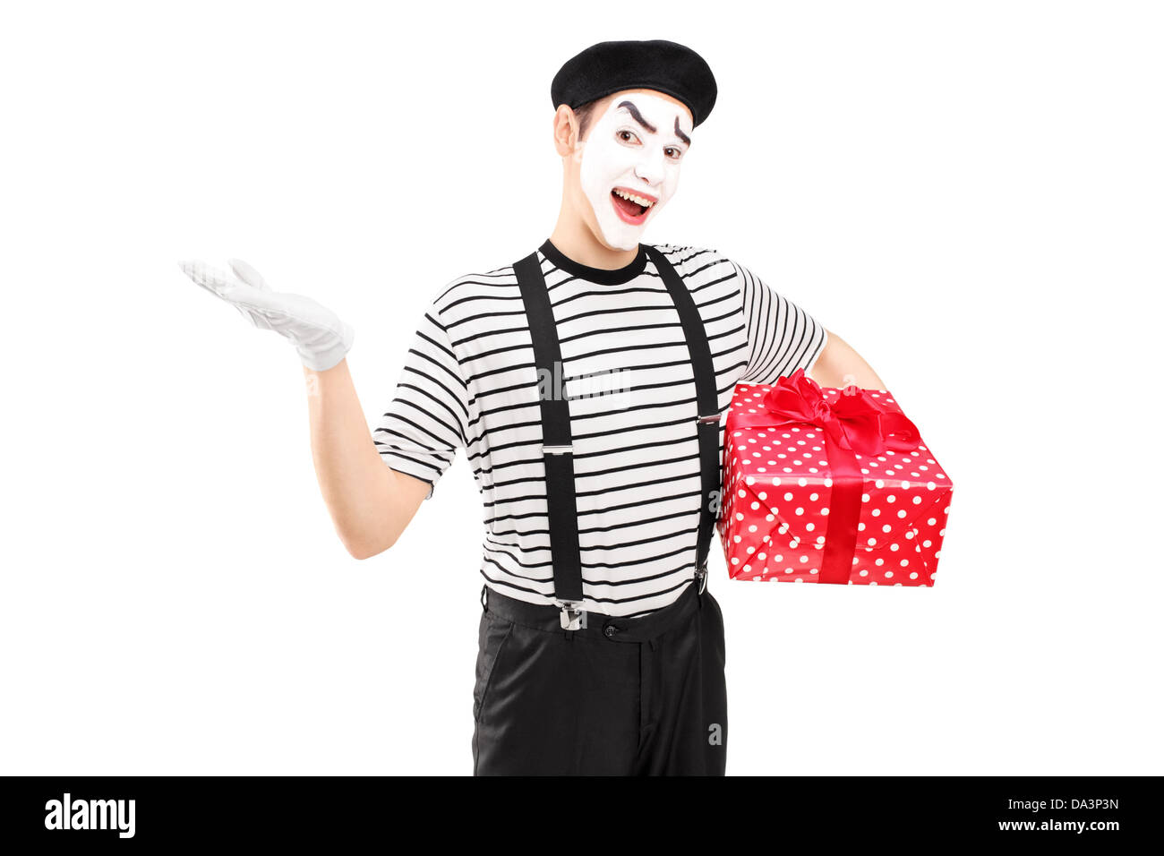 Male mime artist holding a gift box and gesturing with his hand ...