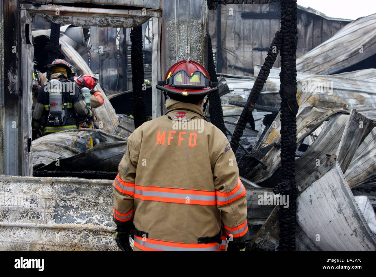 Firefighters working the scene of a fire collapsed industrial building ...