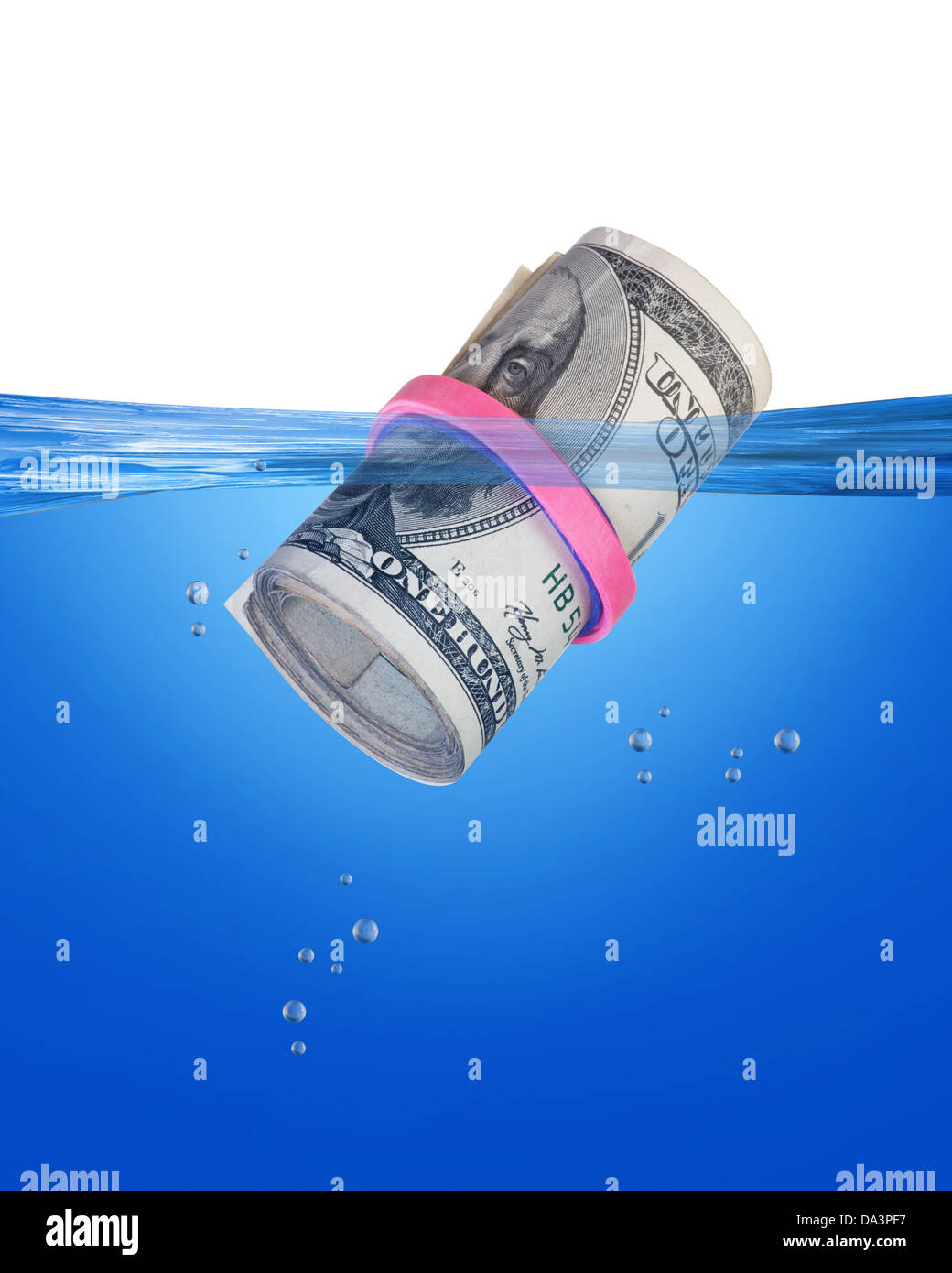 Cash roll floating in blue water Stock Photo - Alamy