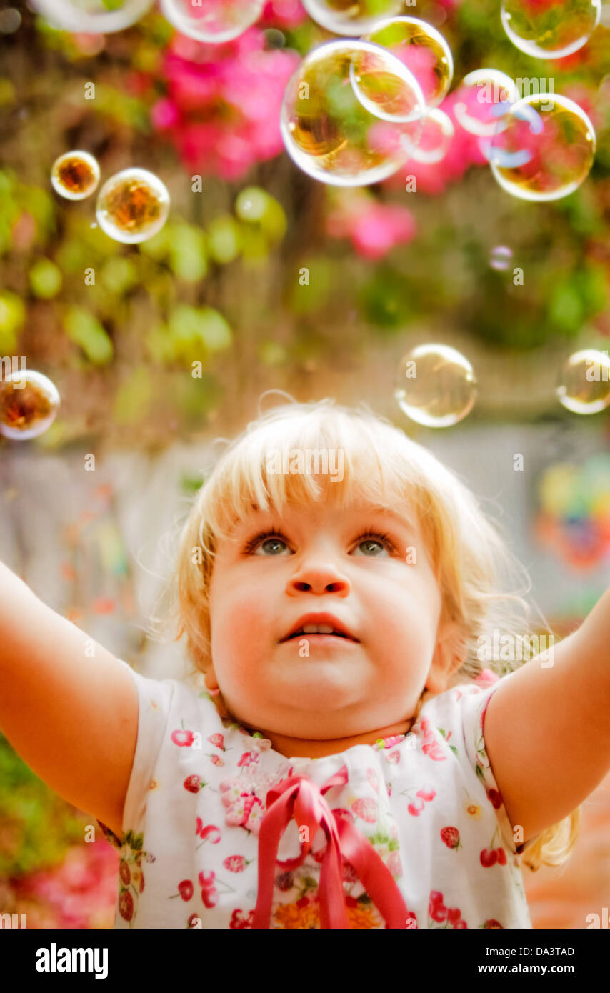 Little girl catching soap bubbles - blond two year old toddler Stock ...