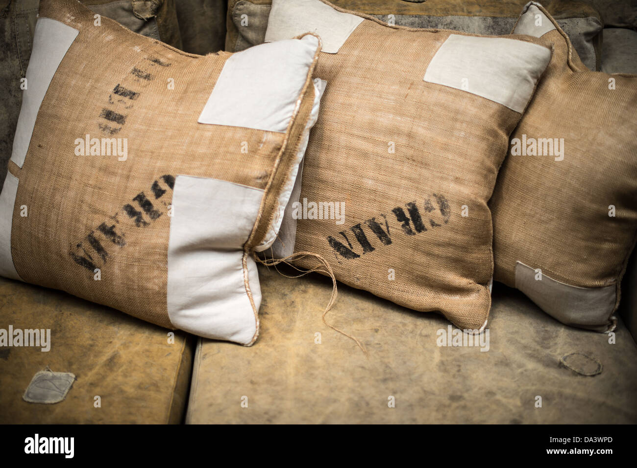Rustic burlap sofa pillows with the words Grain and Feed stamped on ...
