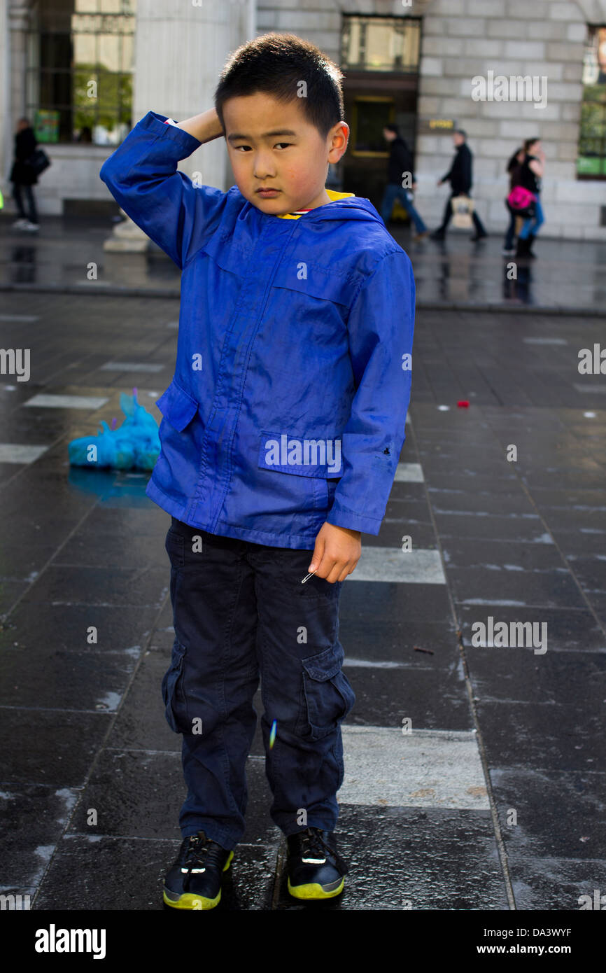 An Asian boy stands at O'Connell Street, Dublin, Ireland Stock Photo ...