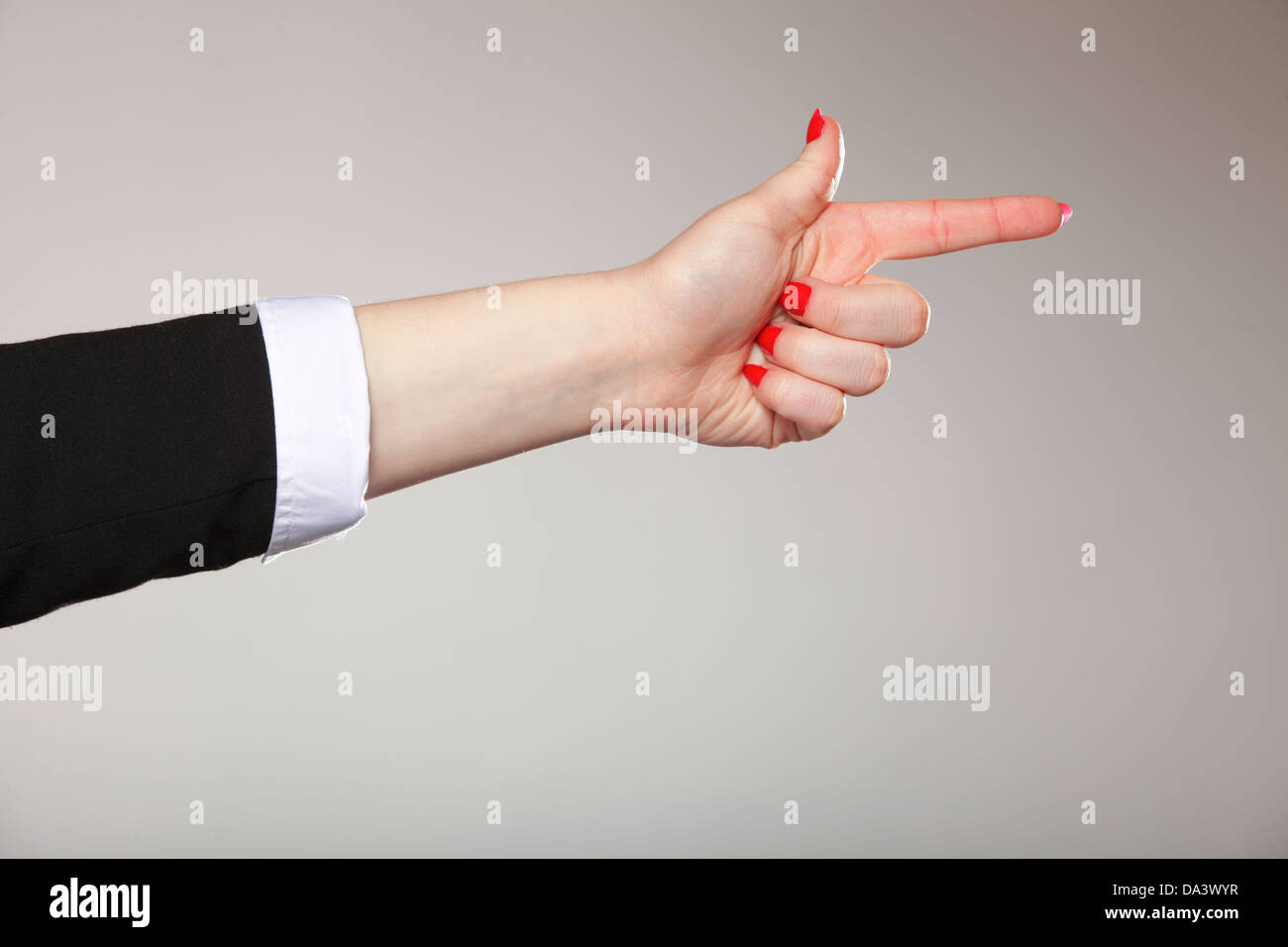 Woman hand pointing direction to follow with index finger gray ...