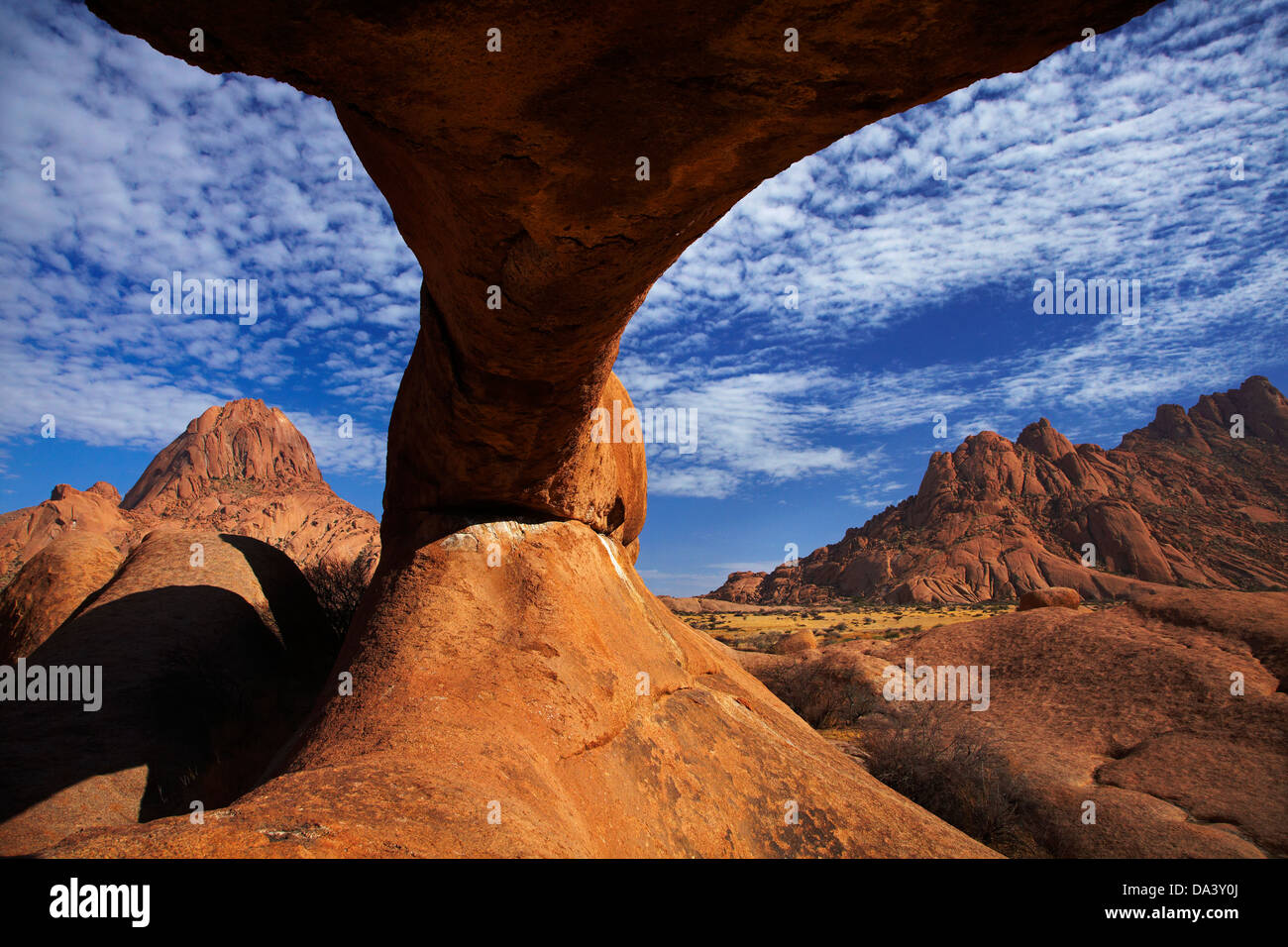 Natural rock arch at Spitzkoppe (left), and Pondok Mountains in distance (right), Namibia ...