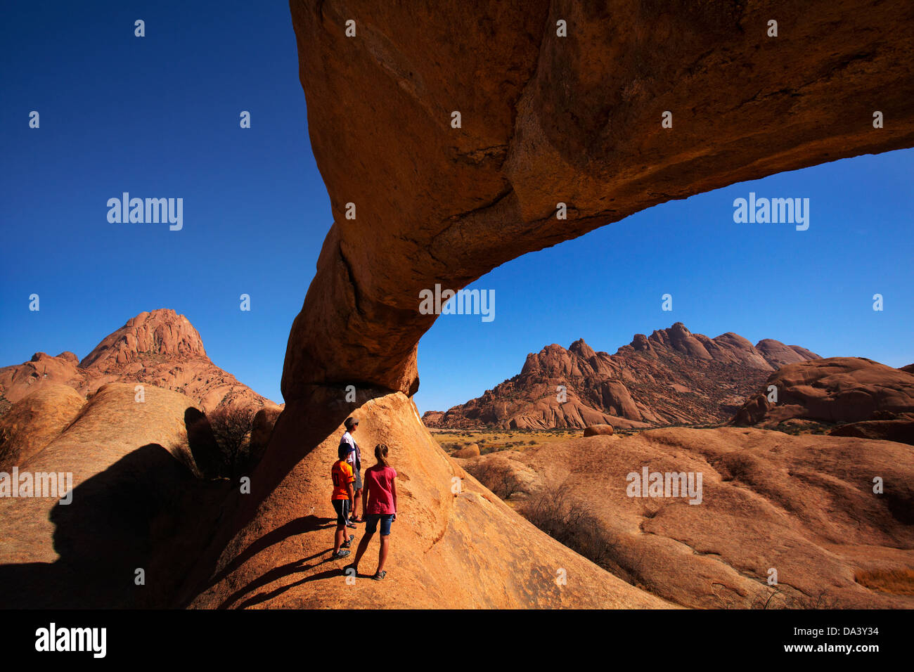 Family under natural rock arch at Spitzkoppe (left), and Pondok ...