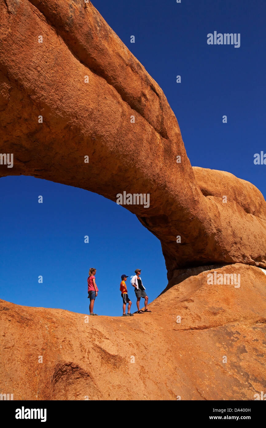 Family under natural rock arch at Spitzkoppe, Namibia, Africa Stock ...