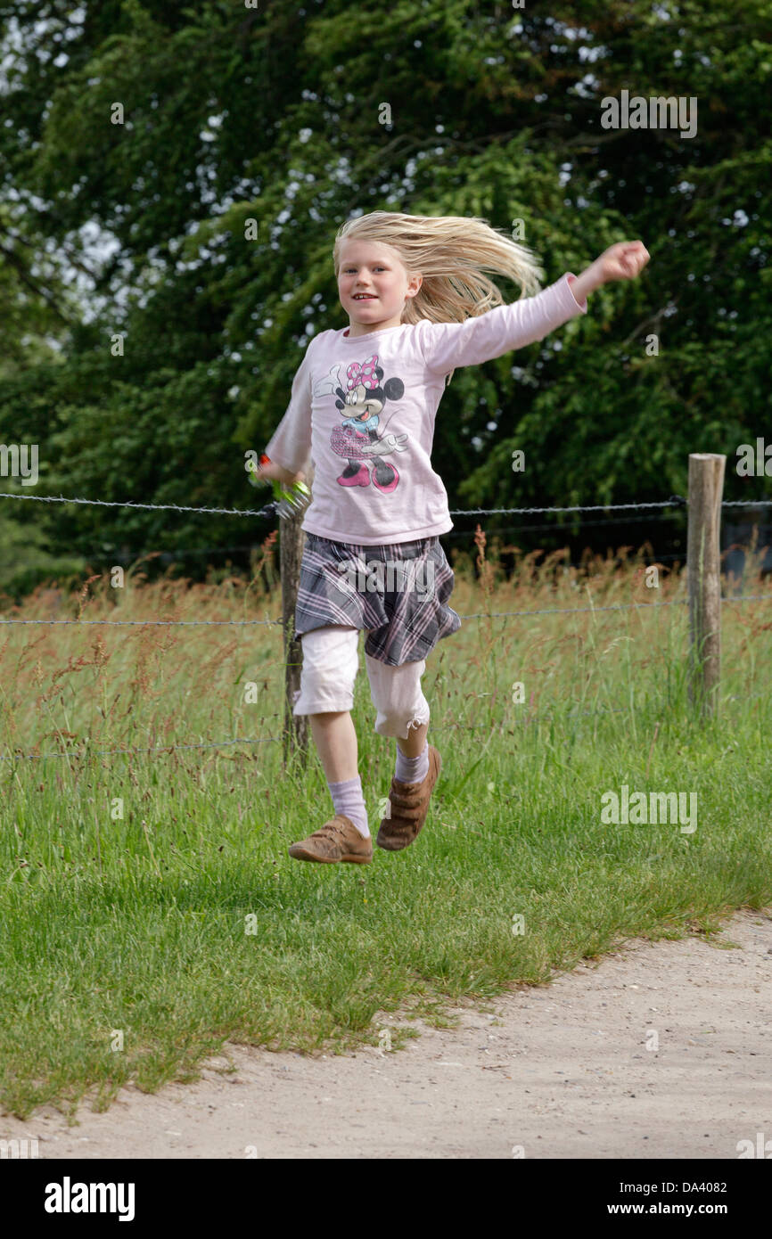 young girl jumping happily Stock Photo - Alamy