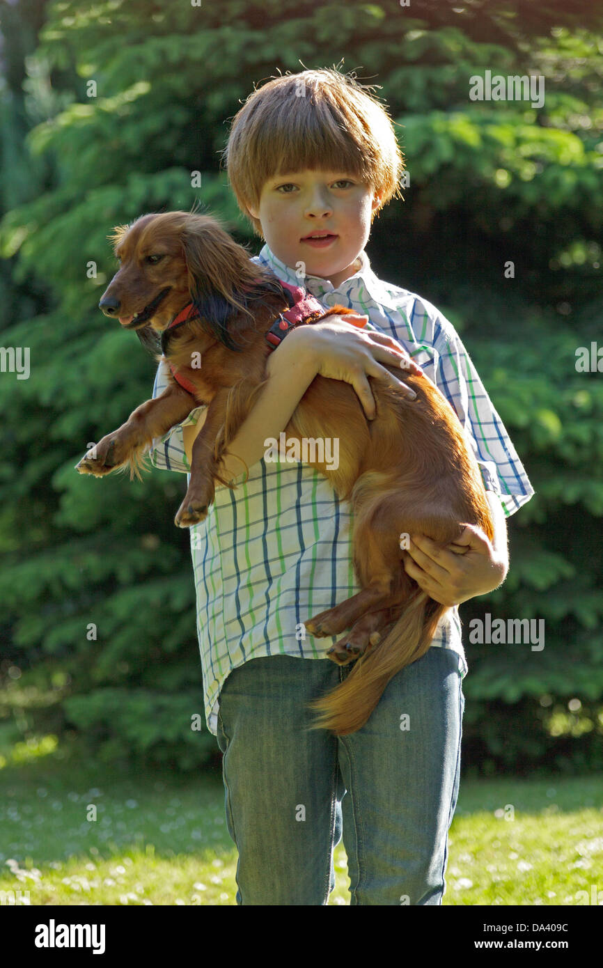 young boy carrying his dog Stock Photo - Alamy