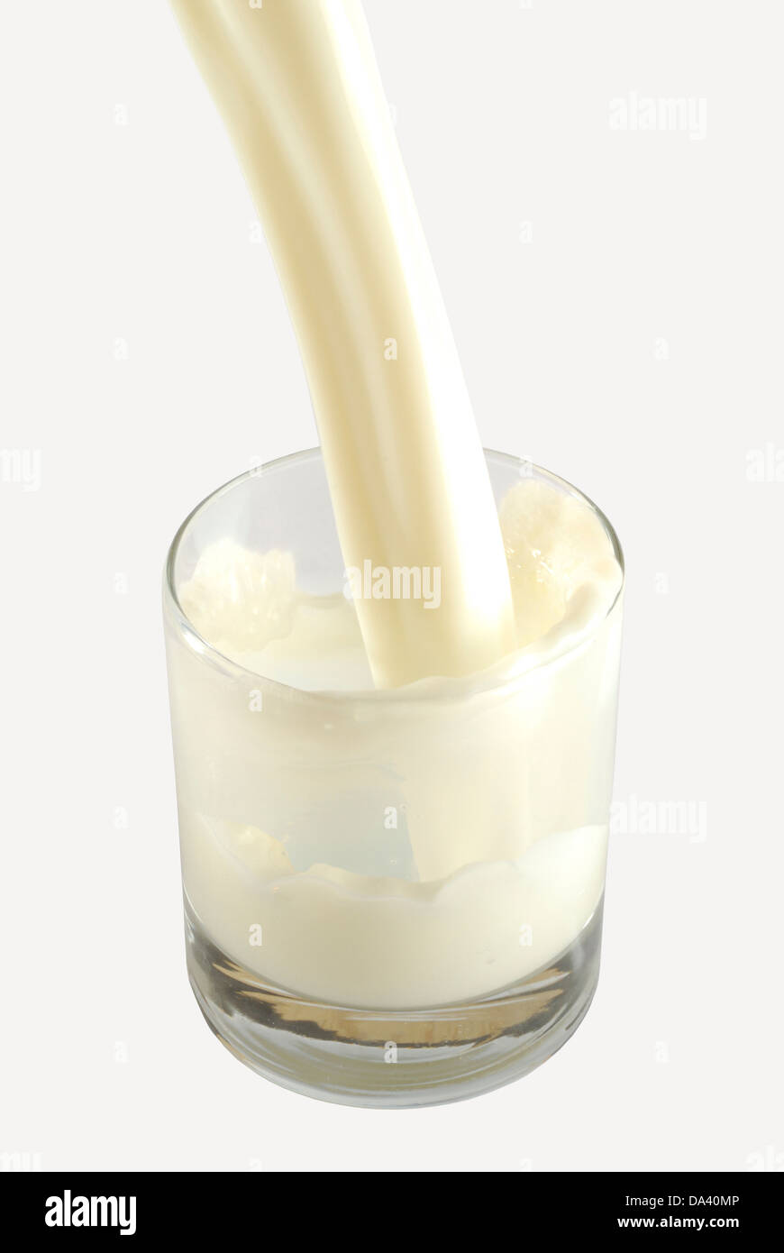 a glass of milk pouring jet Stock Photo - Alamy