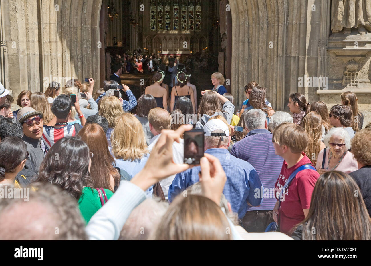 Crowds of people gather at church entrance during a wedding at Bath ...