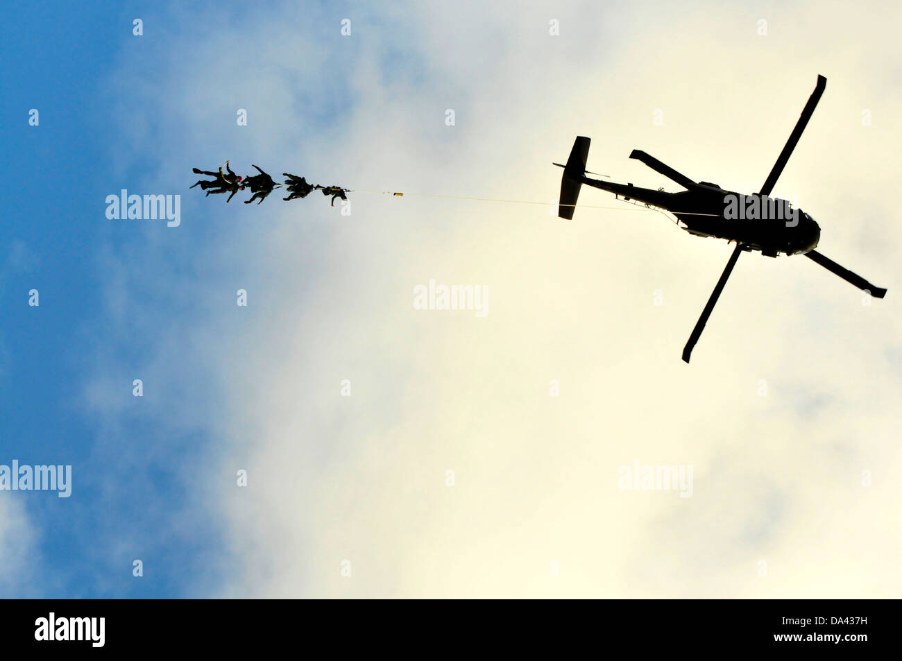 US Navy SEAL team members dangle from the Special Patrol Insertion and ...