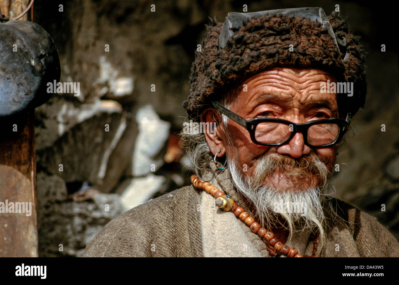 An old Ladakhi man who is a skilled maker of brass items, domestic and ...