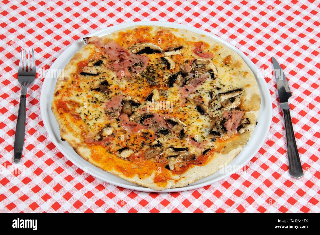 Italian stone baked ham and mushroom pizza on a pizza plate Stock Photo ...