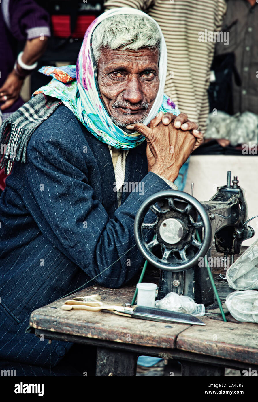 Portrait of a tailor sitting at his sewing table. Jodhpur, Rajasthan ...
