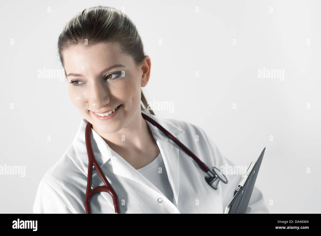 Young female doctor smiling Stock Photo - Alamy